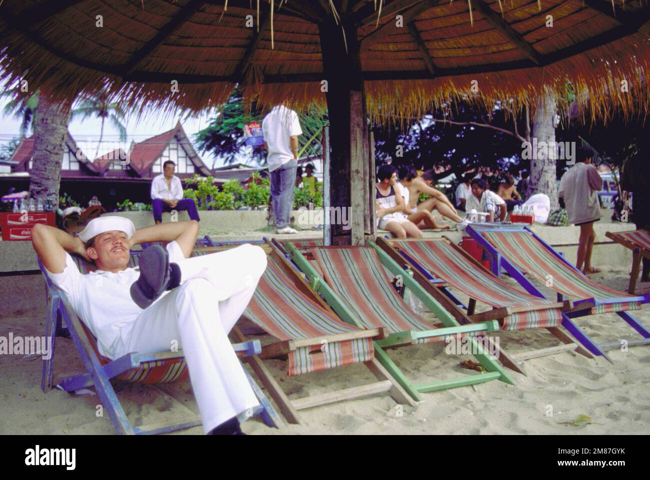 A crew member of the battleship USS NEW JERSEY (BB-62) relaxes while on ...