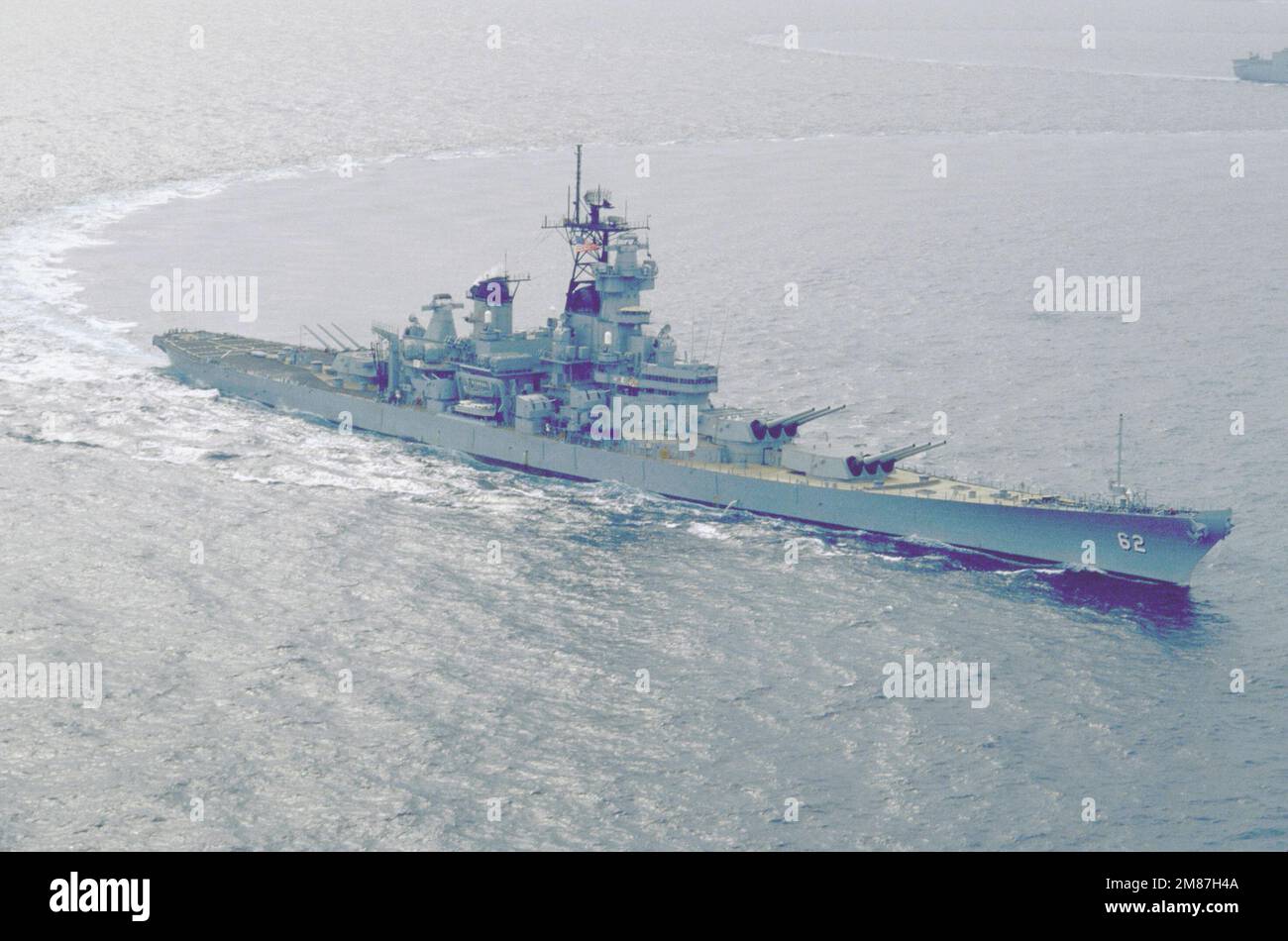 An elevated starboard bow view of the battleship USS NEW JERSEY (BB-62 ...