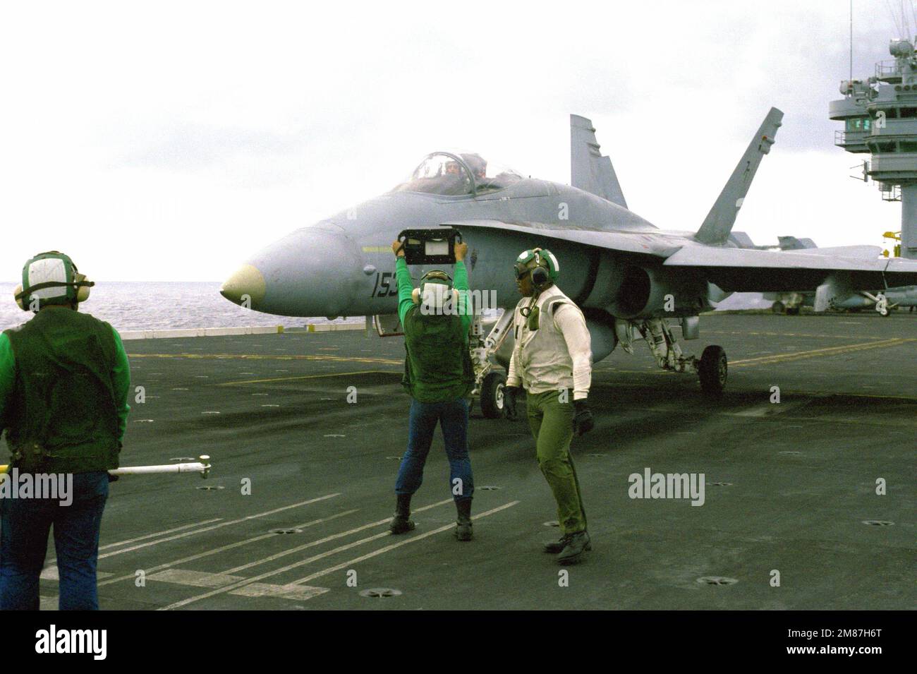 An aircraft handler aboard the nuclear-powered aircraft carrier USS ...