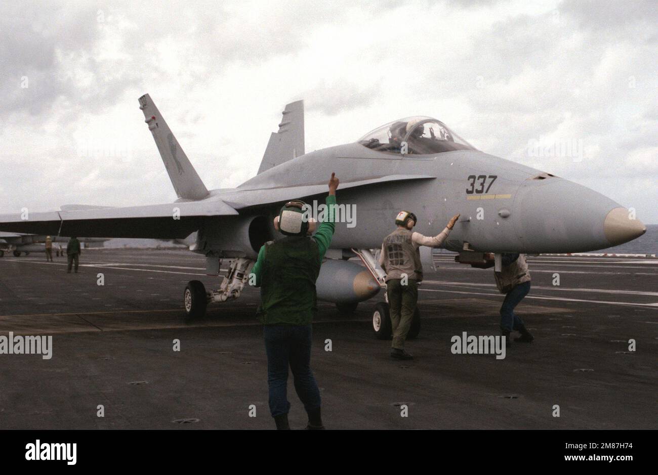 Flight deck crewmen aboard the nuclear-powered aircraft carrier USS ...