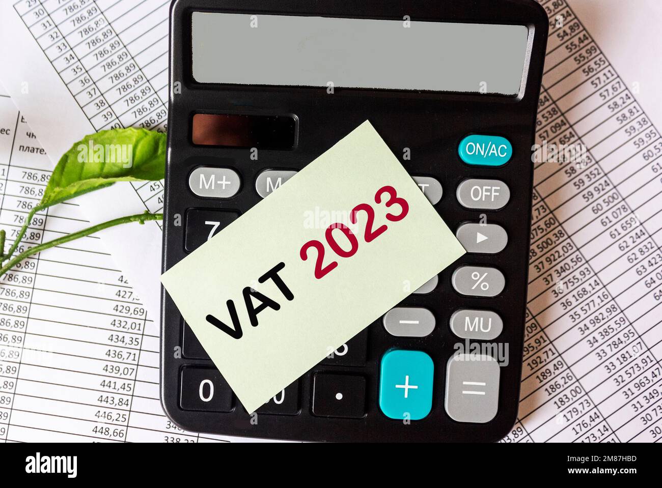 Calculator, documents and reports and a sticker with the text VAT 2023 Stock Photo - Alamy