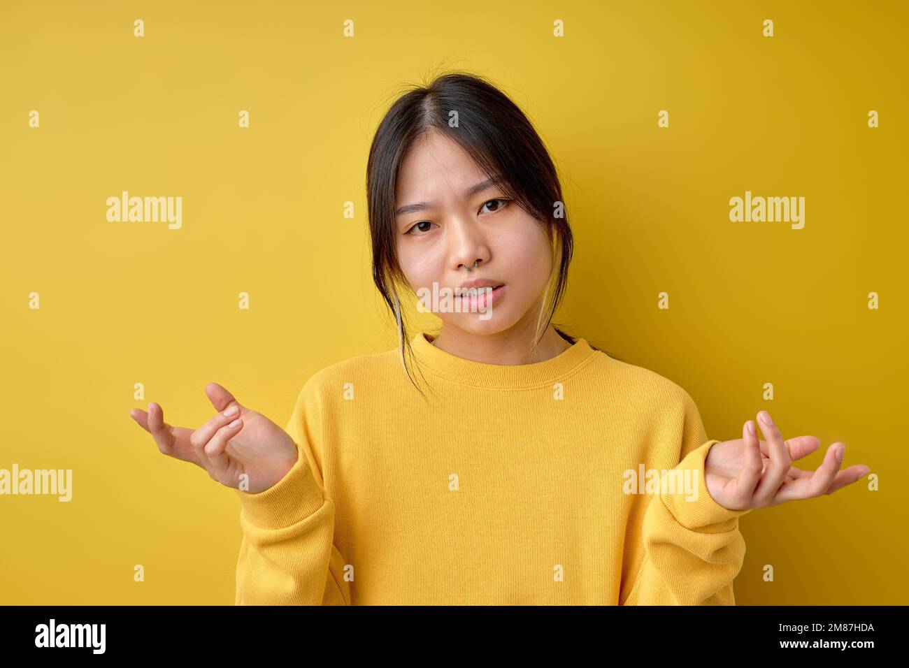 Close up portrait of confused asian woman looking at camera in ...