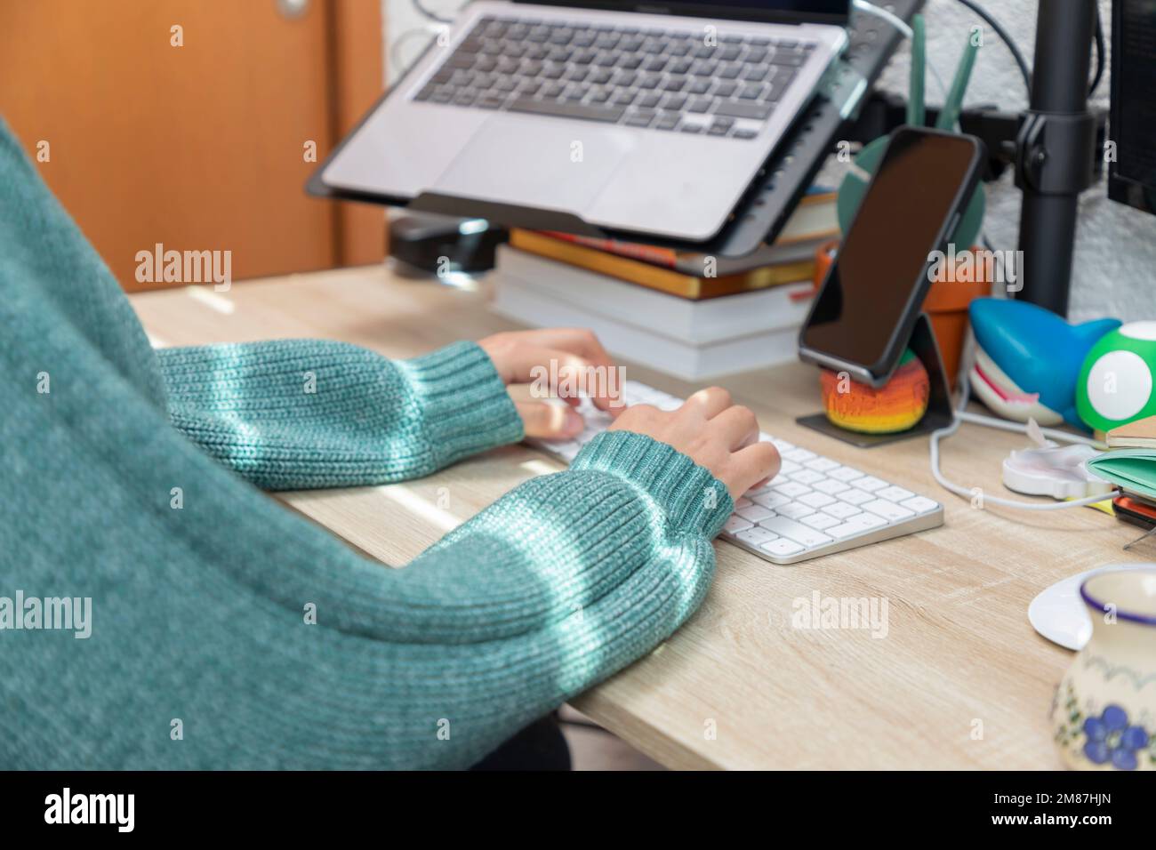 Young woman's hands typing on desktop computer keyboard while working ...