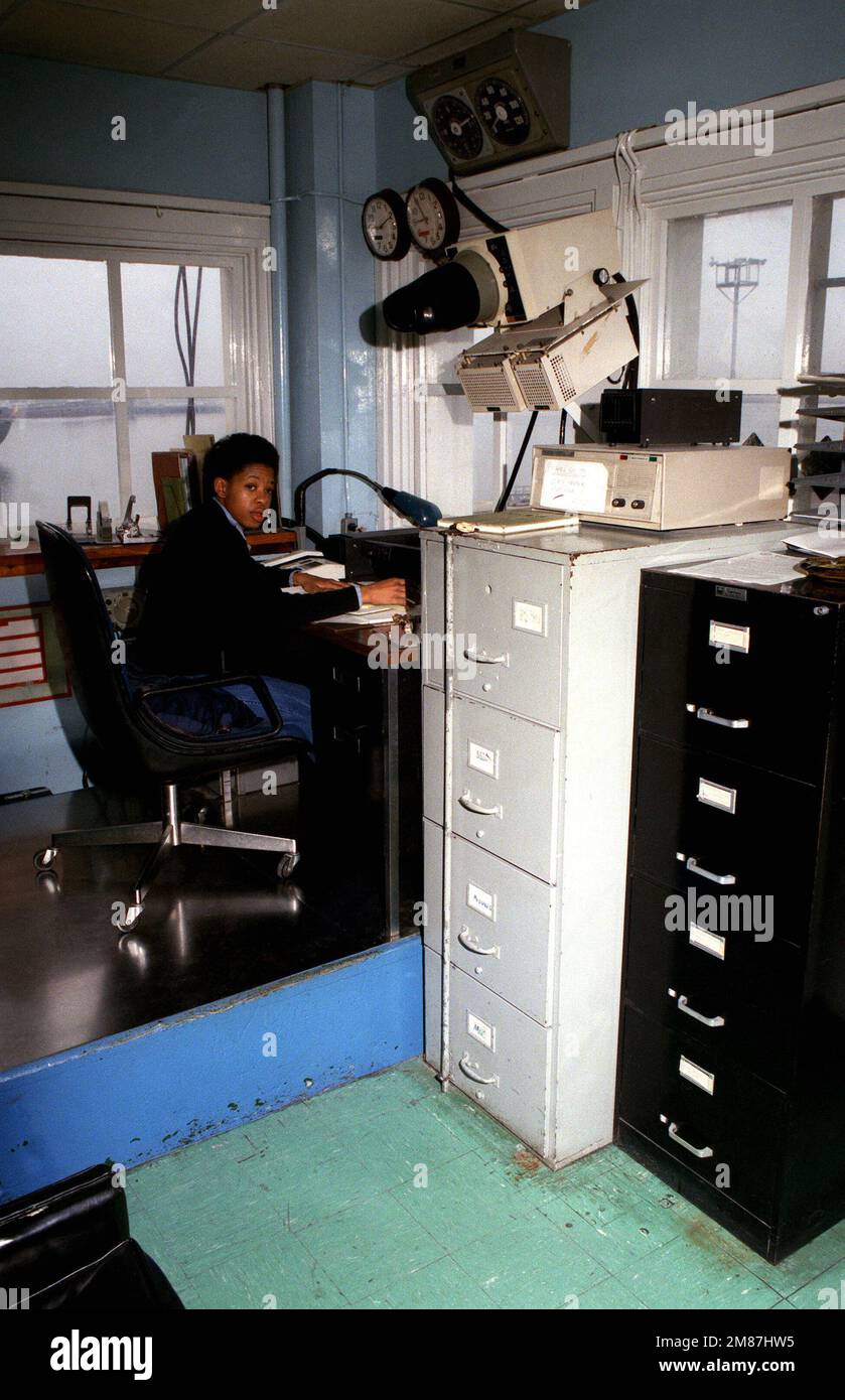 Fireman Apprentice Inger Wilcox works at the dispatcher's desk in the ...