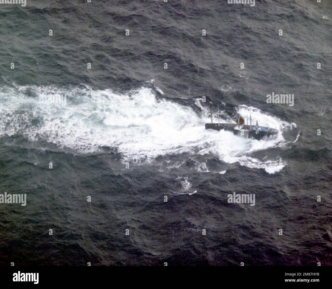 A starboard view of the partially submerged sail of a Soviet Kilo class ...