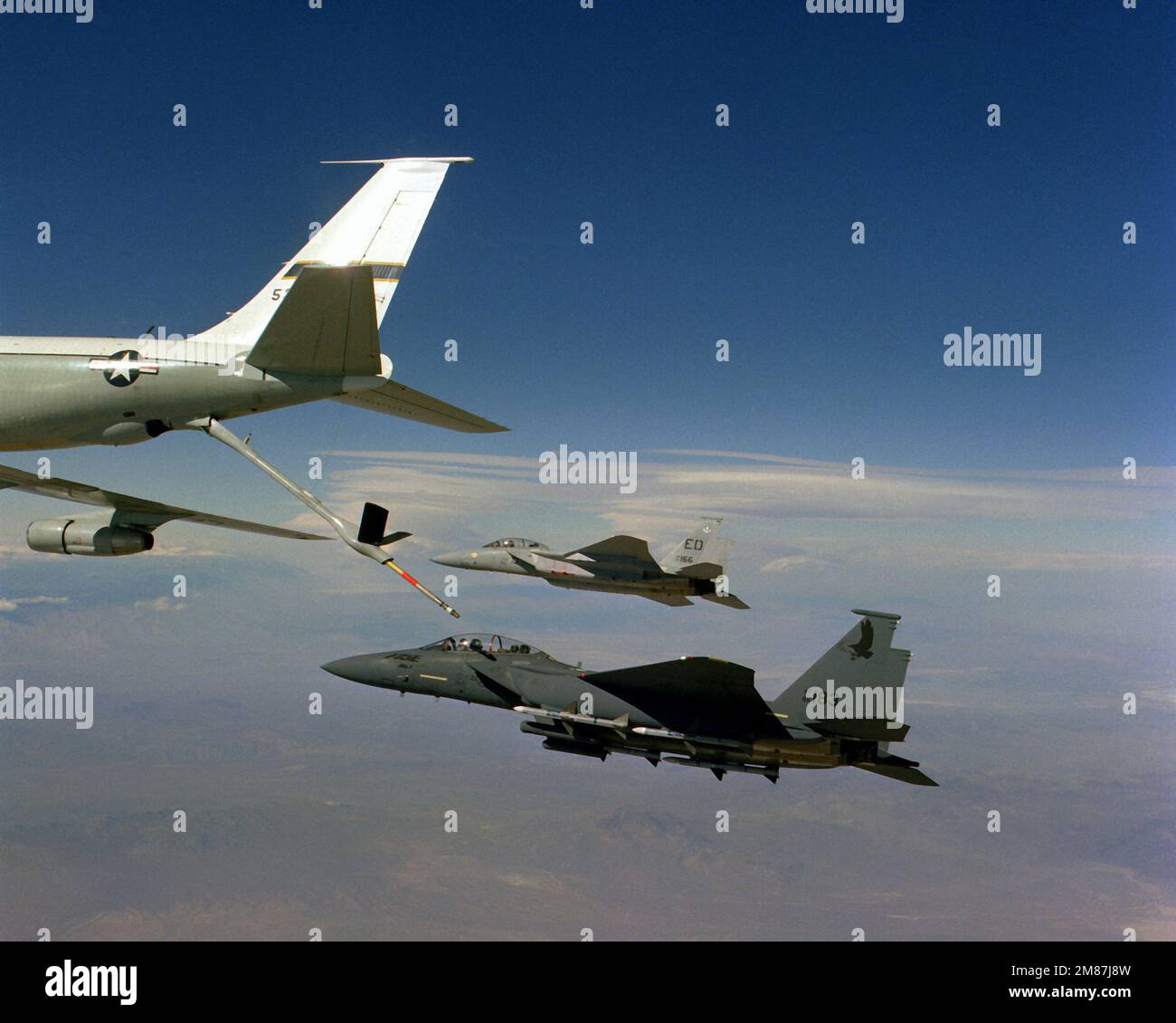 An F-15E Eagle aircraft approaches the refueling boom of a KC-135 ...