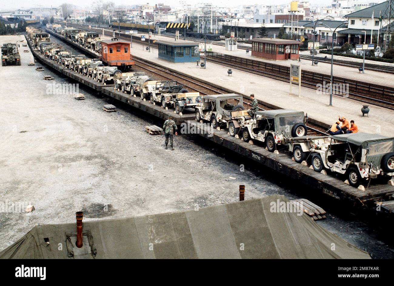 A train carrying M-151 light vehicles arrives at the railhead for ...