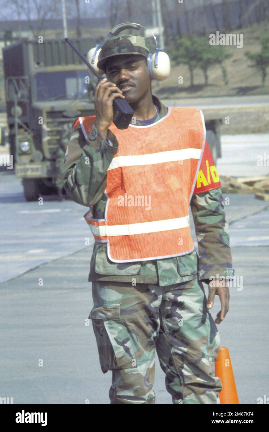 Specialist 4 Joseph Tremble uses a walkie-talkie to relay a message as ...