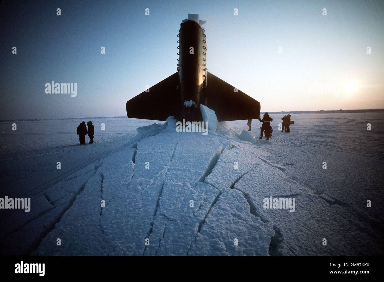 Crewmen examine the sail of the nuclear-powered attack submarine USS ...