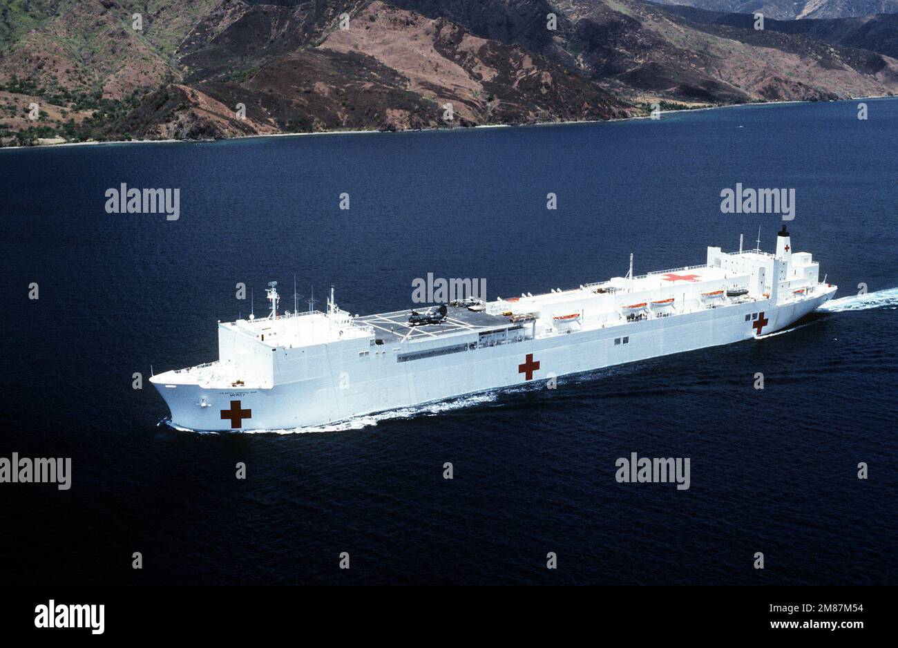 A port bow view of the hospital ship USNS MERCY (T-AH-19) underway in ...