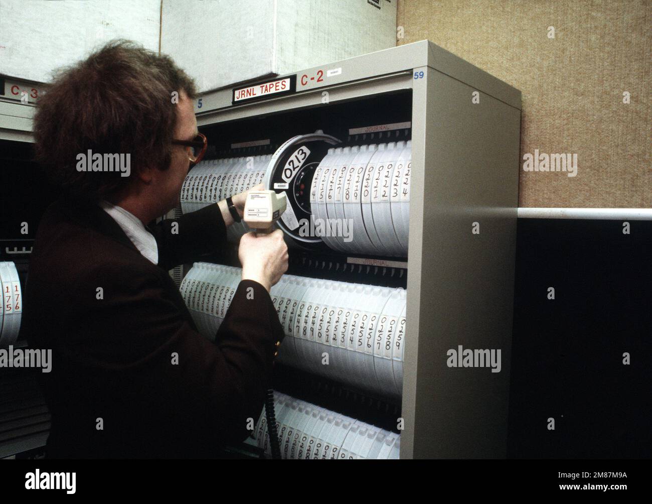 A government employee screens bar codes in the Computer Room of the ...