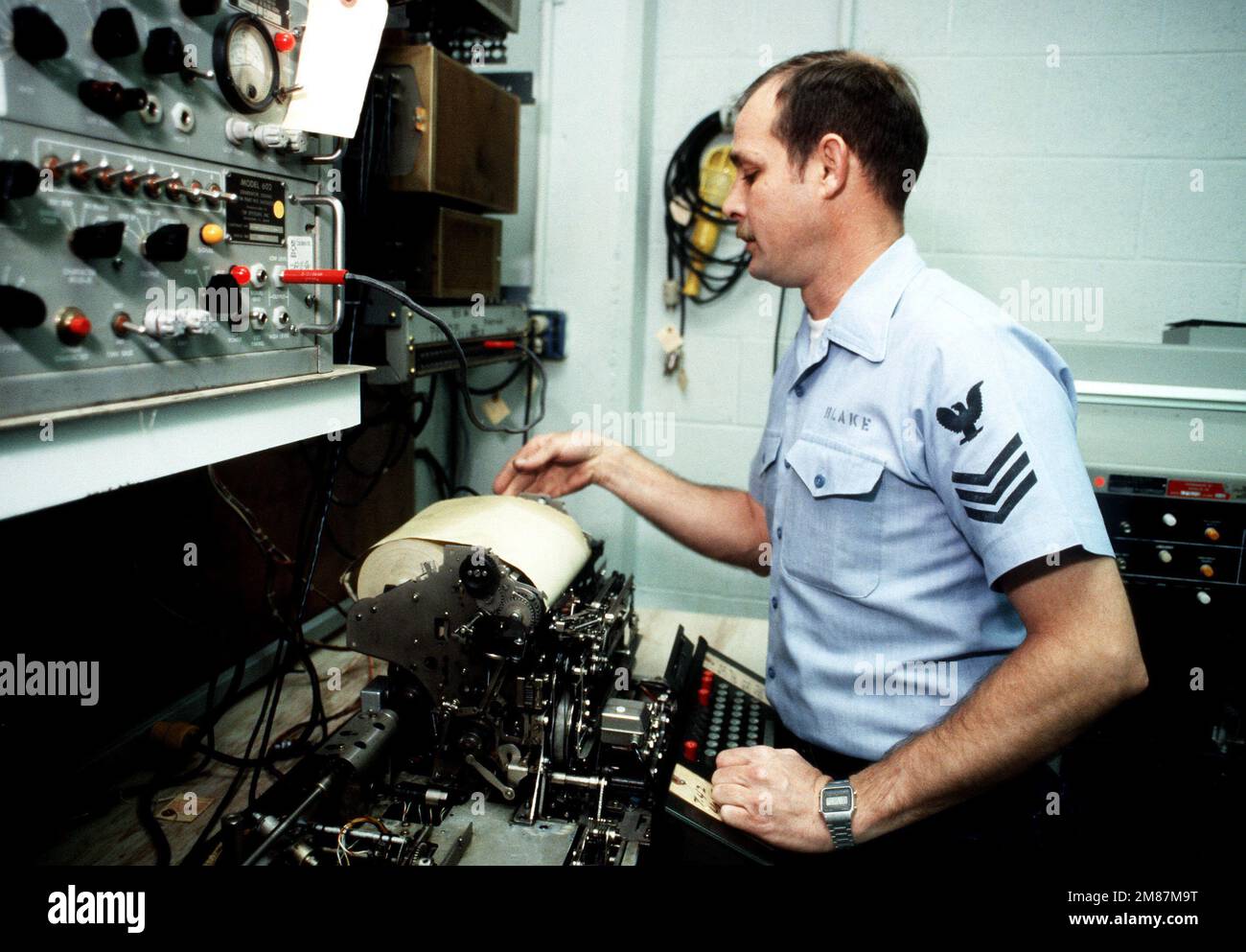 Repairman 1ST Class Blake repairs a teletype machine in the Repair Shop of the Naval ...