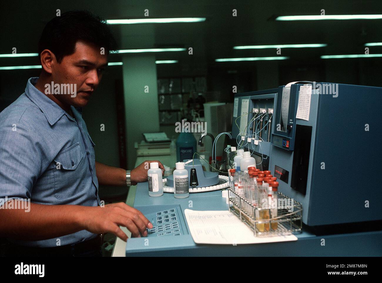 A hospital corpsman conducts a test in the chemical analysis laboratory ...