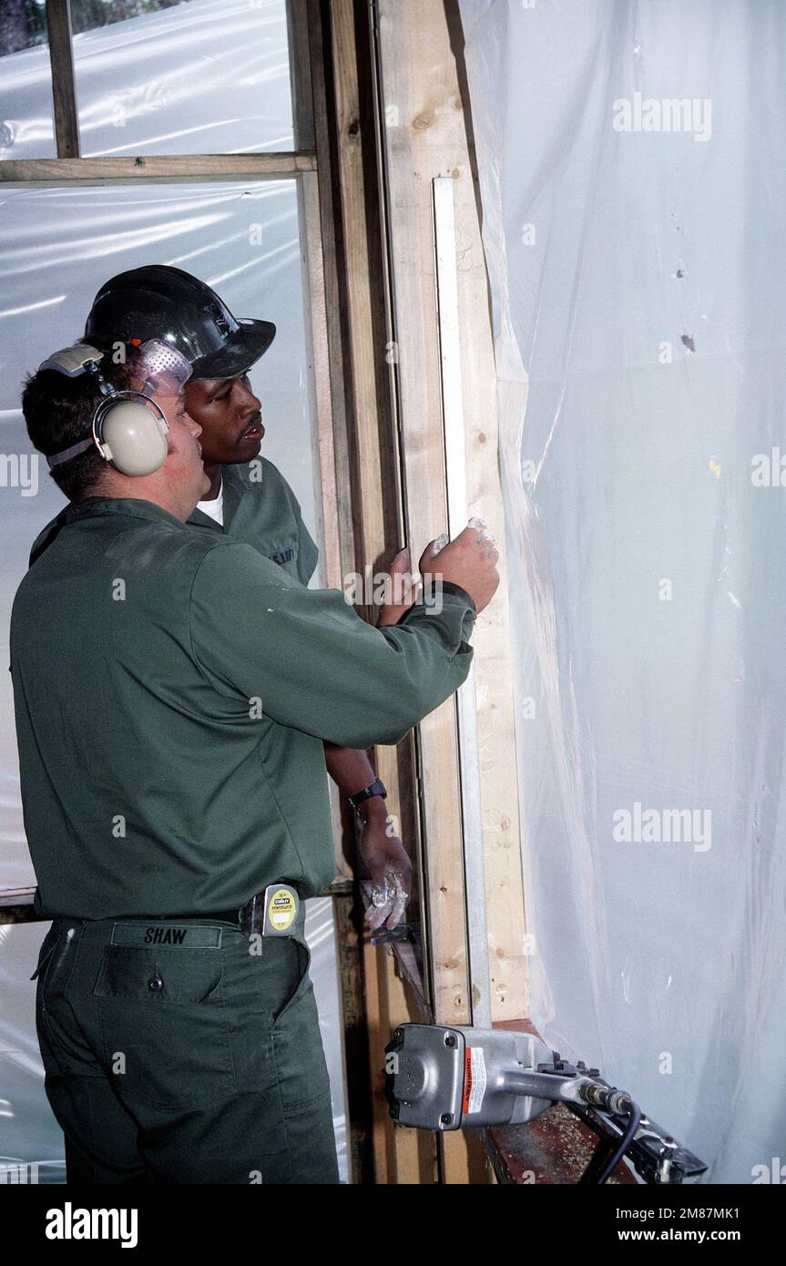 A Construction Battalion Unit 412 (CBU-412) builders position sections ...