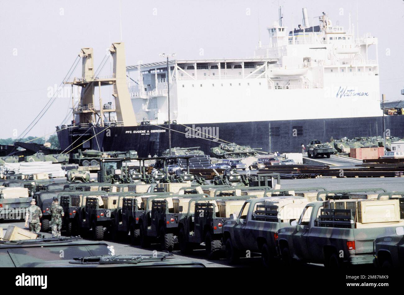 Military vehicles are lined to be loaded aboard the maritime ...