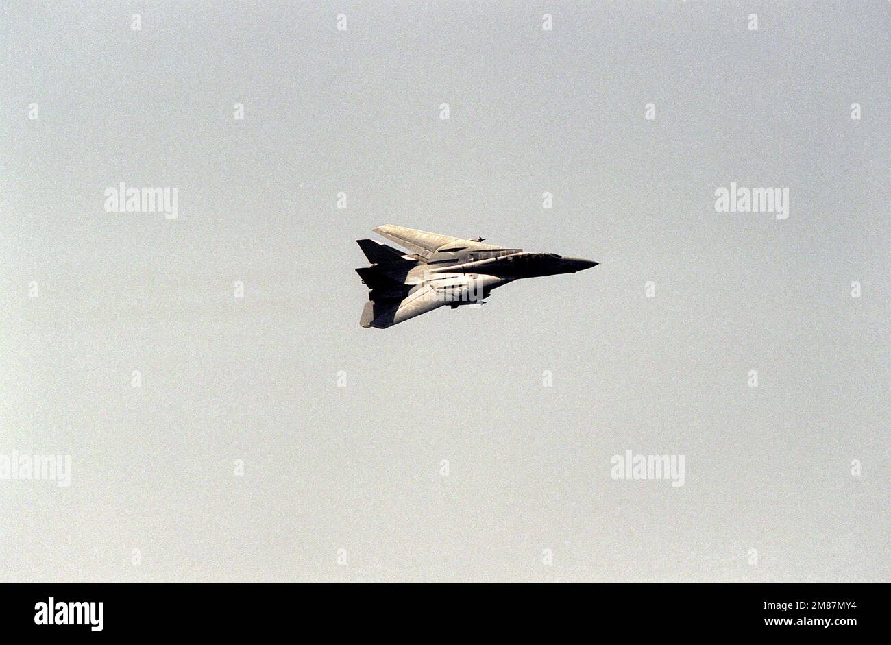An F-14A Tomcat aircraft banking to the left. Country: Indian Ocean ...