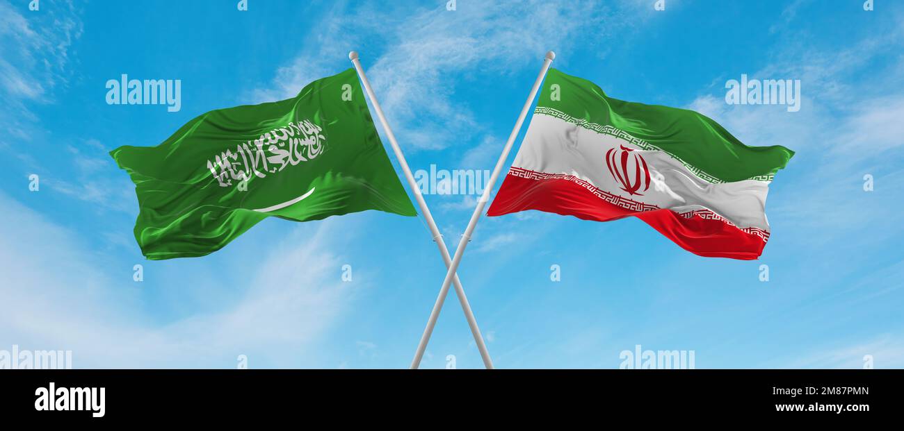 two crossed flags Iran and Saudi Arabia waving in wind at cloudy sky ...