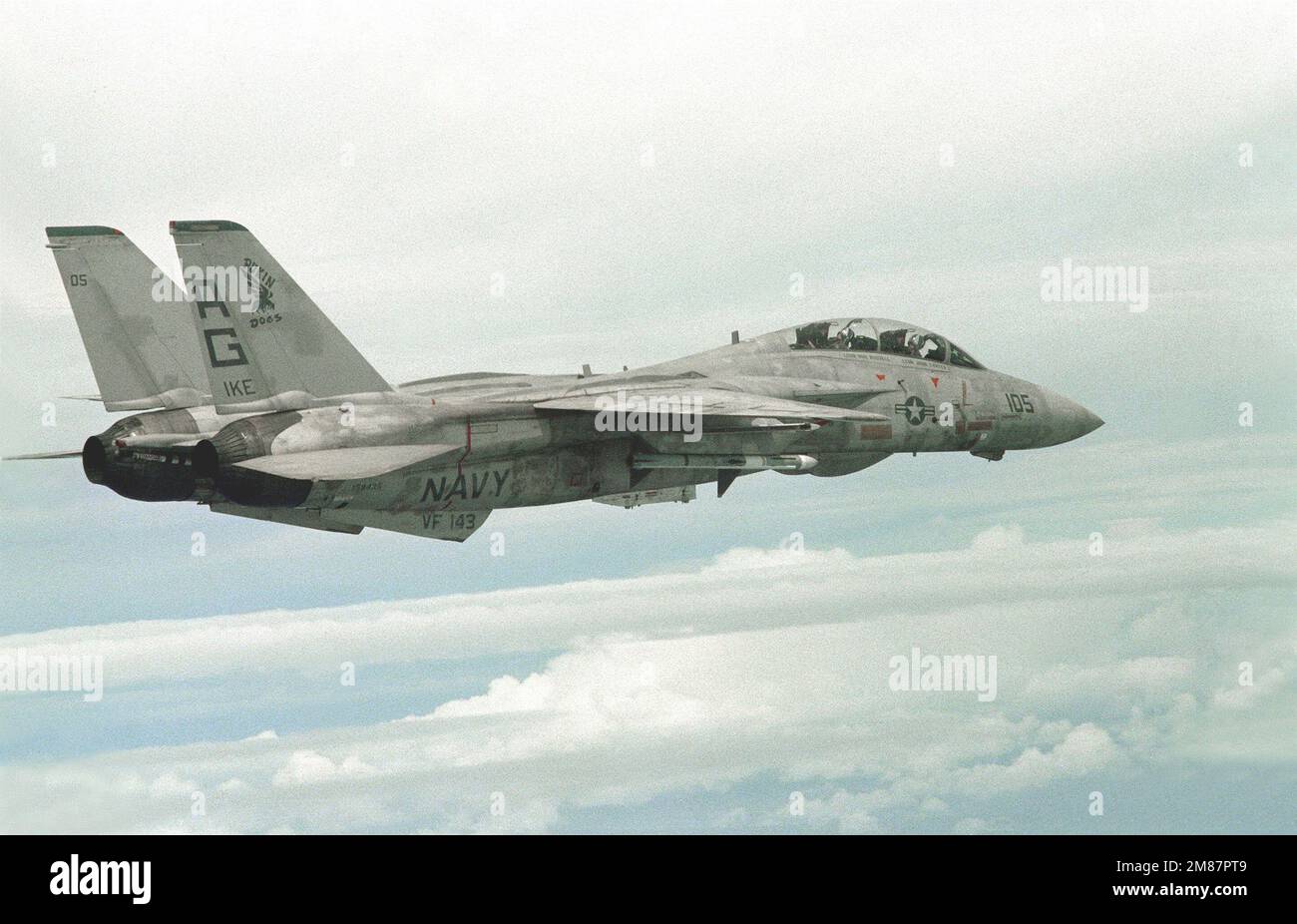 An air-to-air right side view of a Fighter Squadron 143 (VF-143) F-14A Tomcat aircraft armed ...