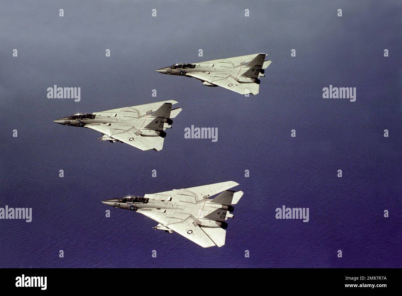 An air-to-air left side view of three Fighter Squadron 143 (VF-143 F ...