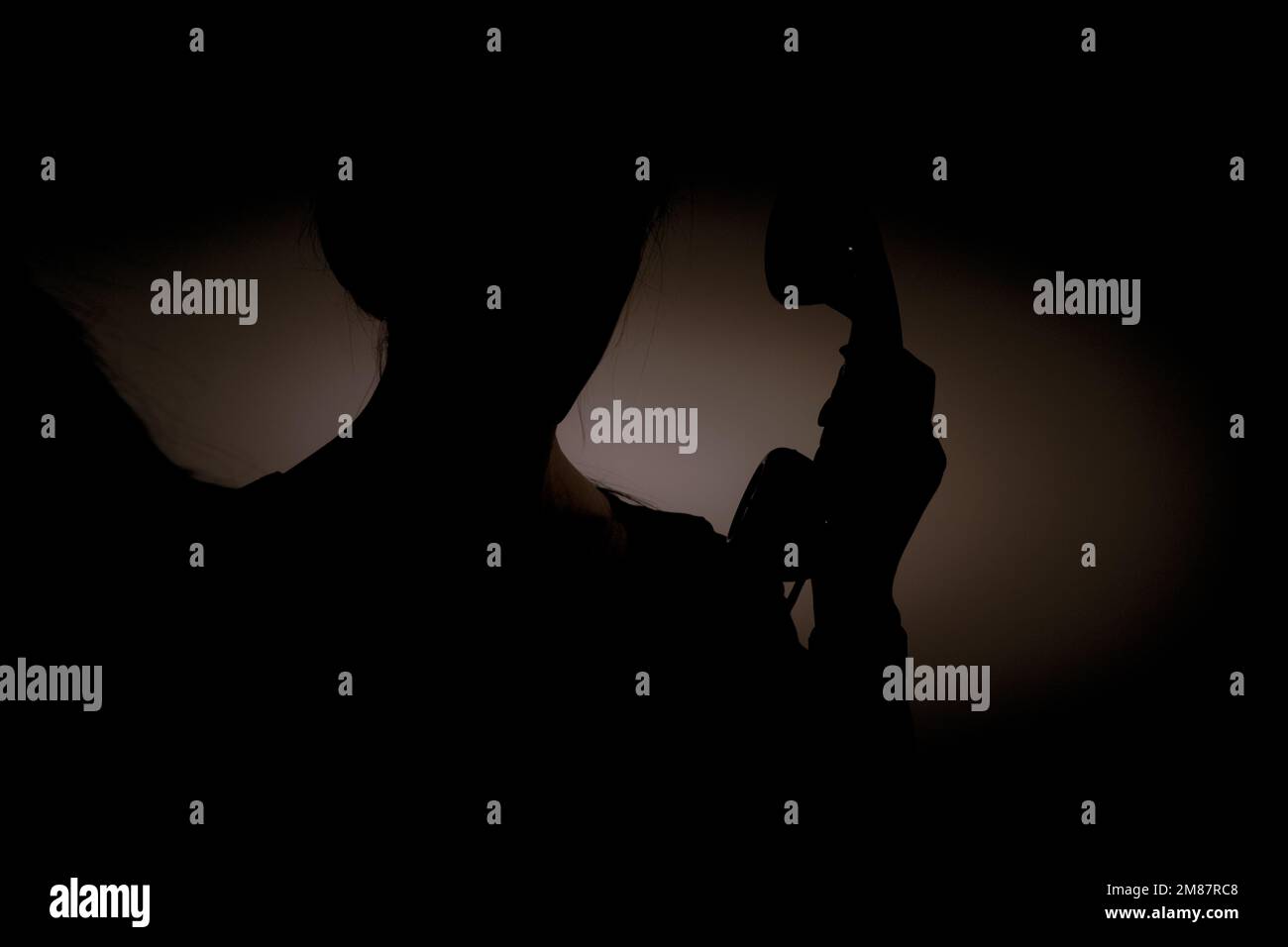 The girl calls in the dark on an old phone, calls, talking on the phone ...