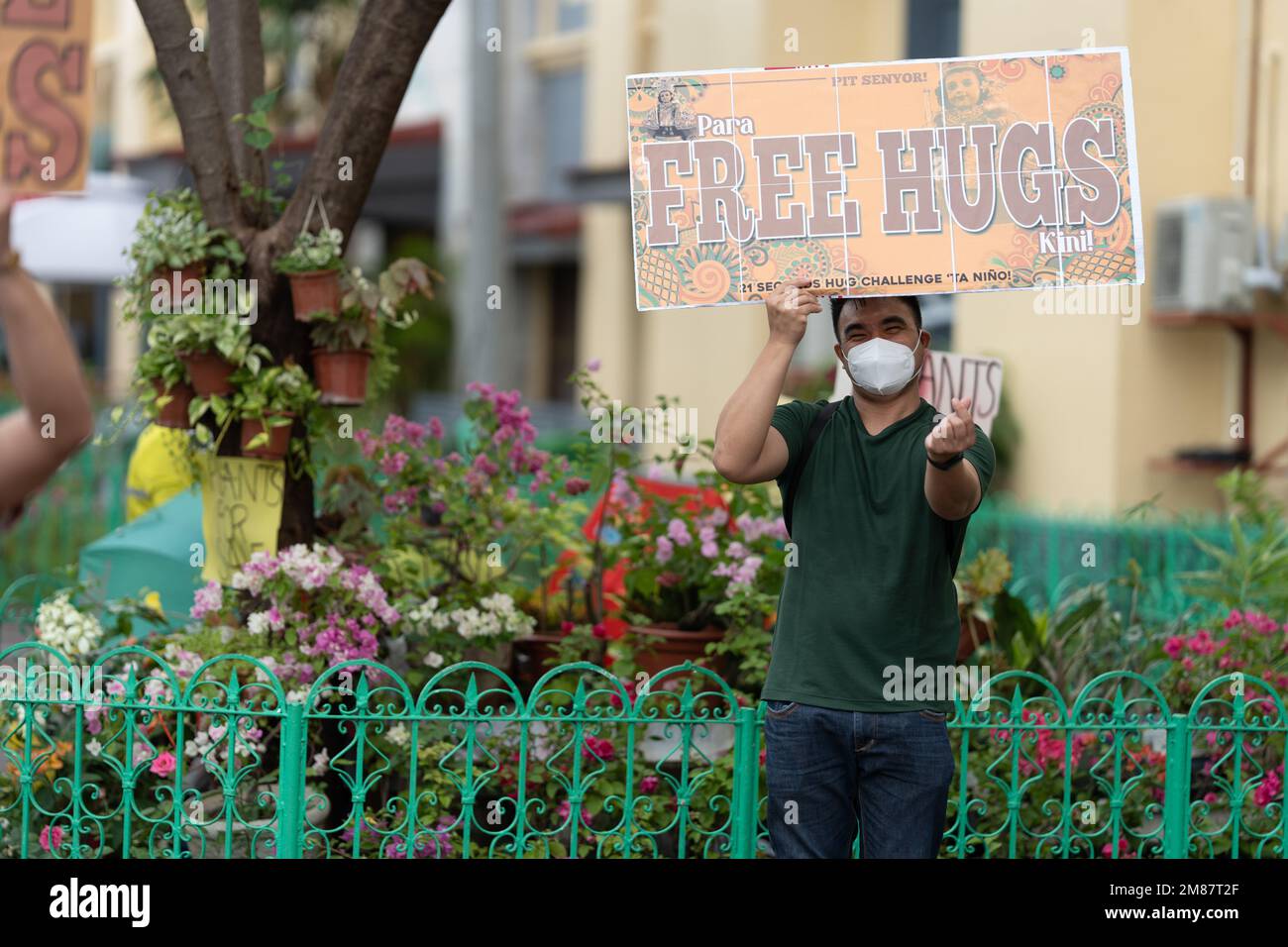 A man holding a free hugs sign during the annual Sinulog festival Cebu ...