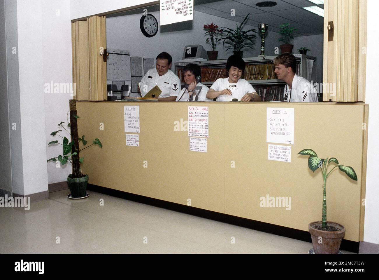 U.S. Navy corpsmen perform their duties at the main reception desk at ...