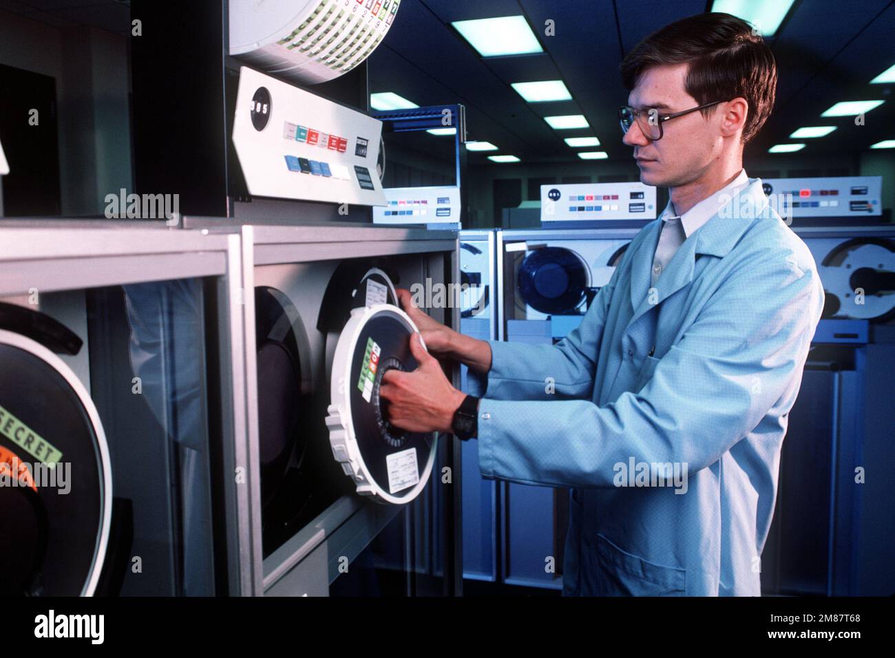 STAFF SGT. Jon Loehndorf of the 2nd Space Wing changes a computer tape ...