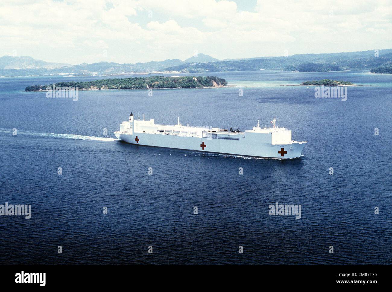 A starboard view of the hospital ship USNS MERCY (T-AH-19) passing ...