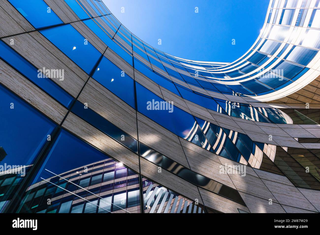 A low-angle shot of a modern building's glass facade Stock Photo - Alamy