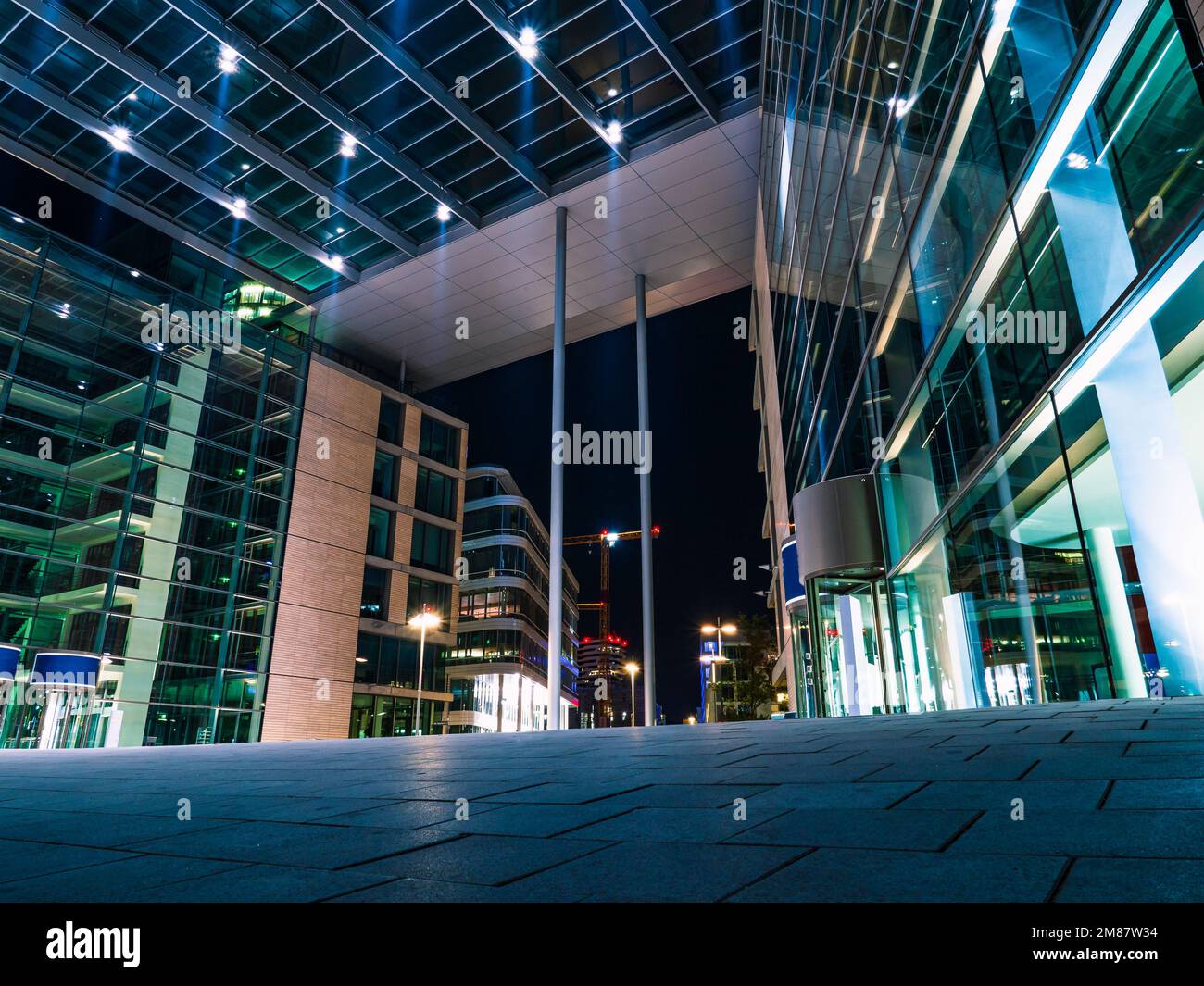 A modern building with a glass facade at night in Stuttgart, Germany ...