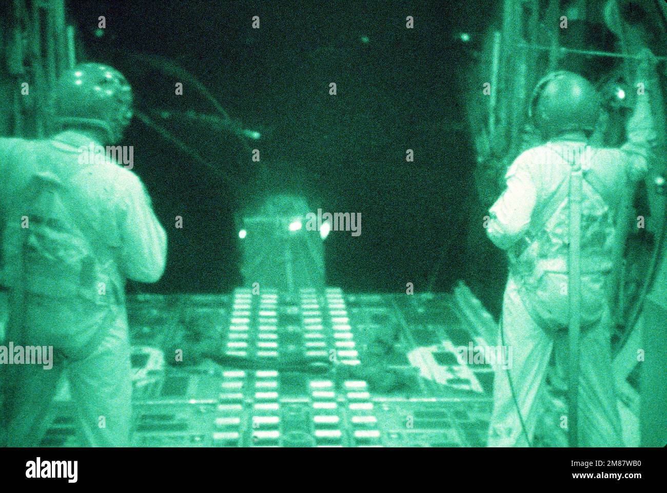 Crewmen release a bundle of materiel from an airborne MC-130 Hercules ...