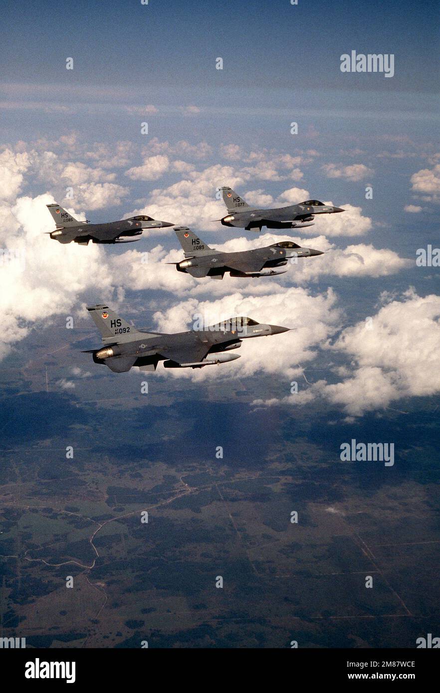 An air-to-air right view of four 308th Tactical Fighter Squadron F-16 ...