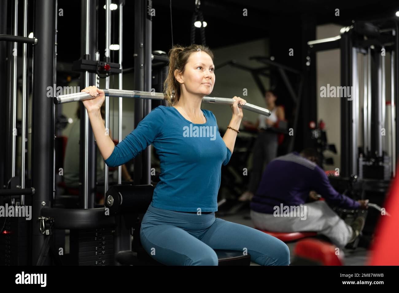 Woman is engaged in a simulator for development of back muscles Stock ...
