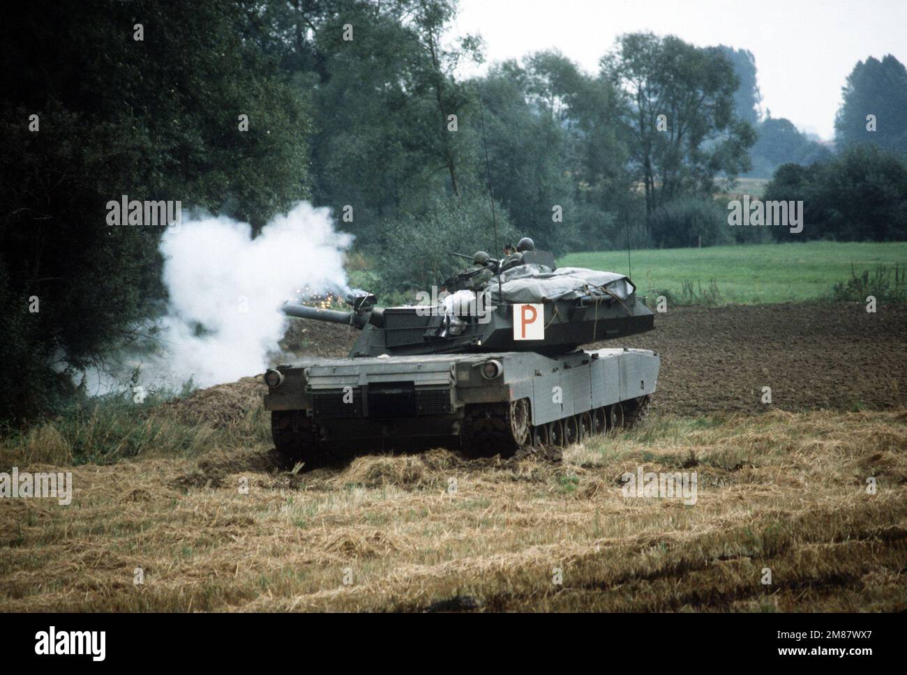 A right side view of three M1 Abrams main battle tanks in a firing line ...