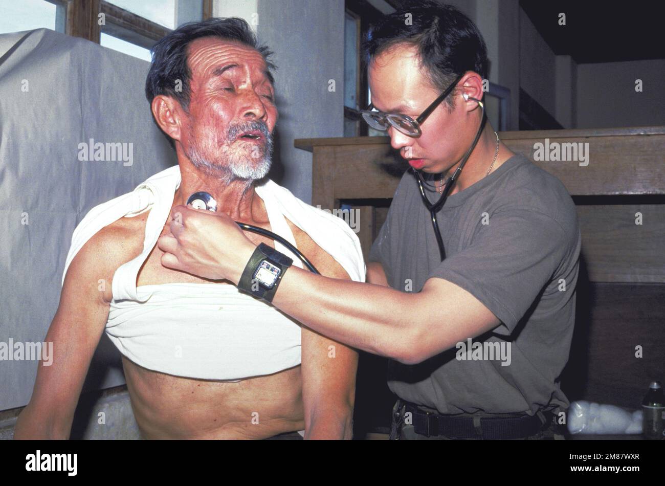 CAPT. (Dr.) Jerry Yee examines a patient during the joint Bolivia/U.S ...