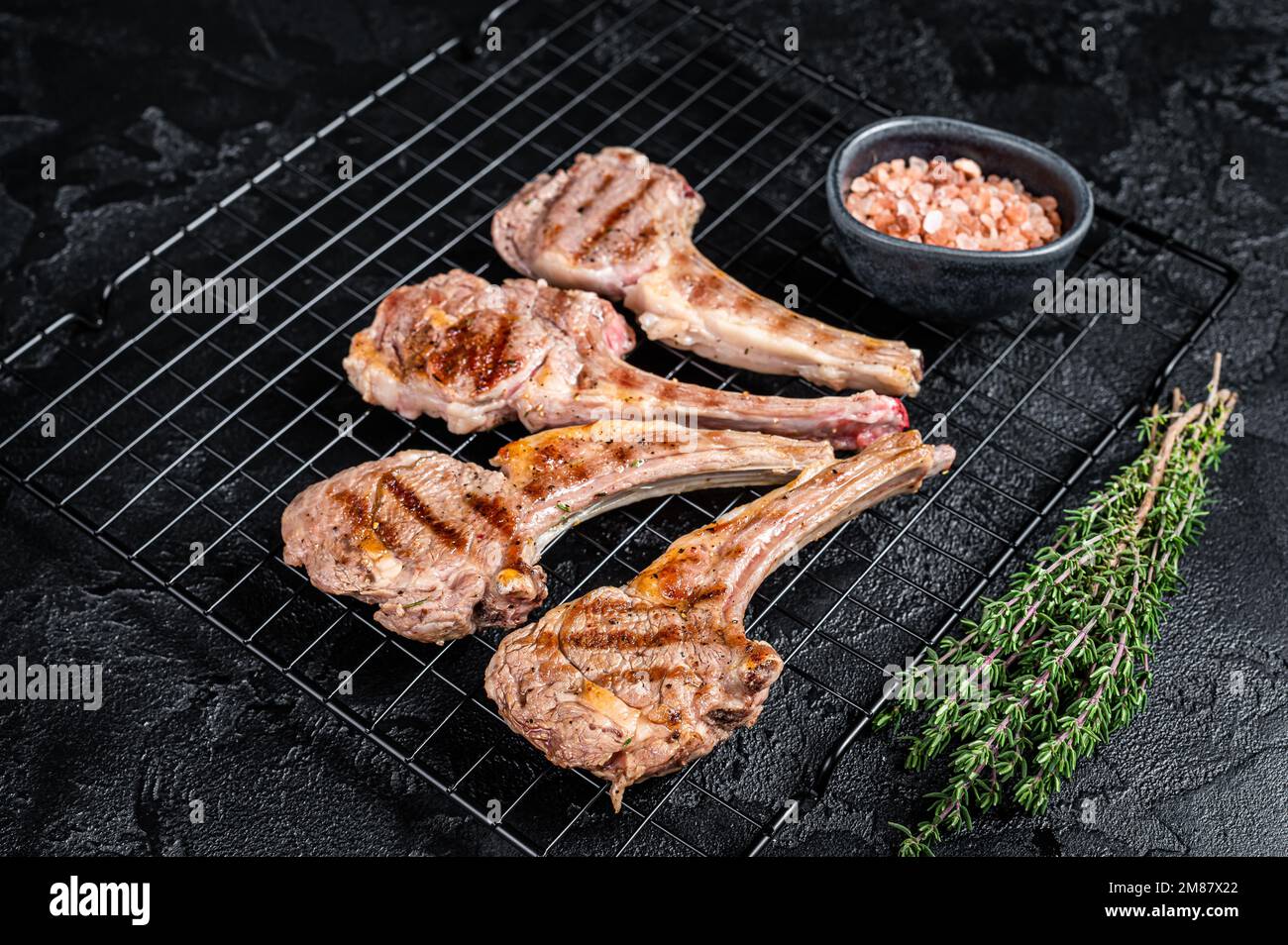 Barbecue Grilled lamb meat chops, mutton cutlets. Black background. Top ...