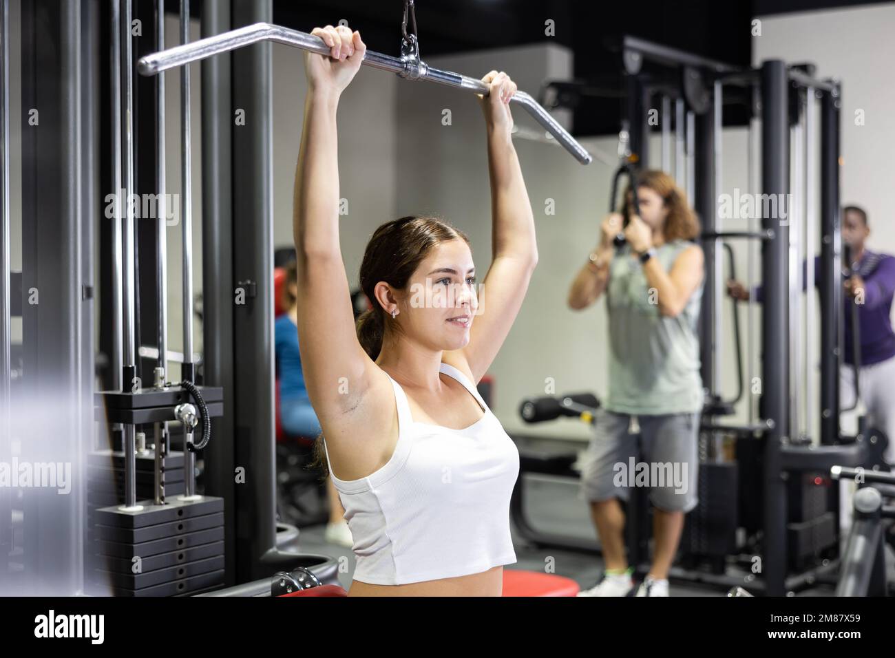Woman is engaged in a simulator for development of back muscles Stock ...