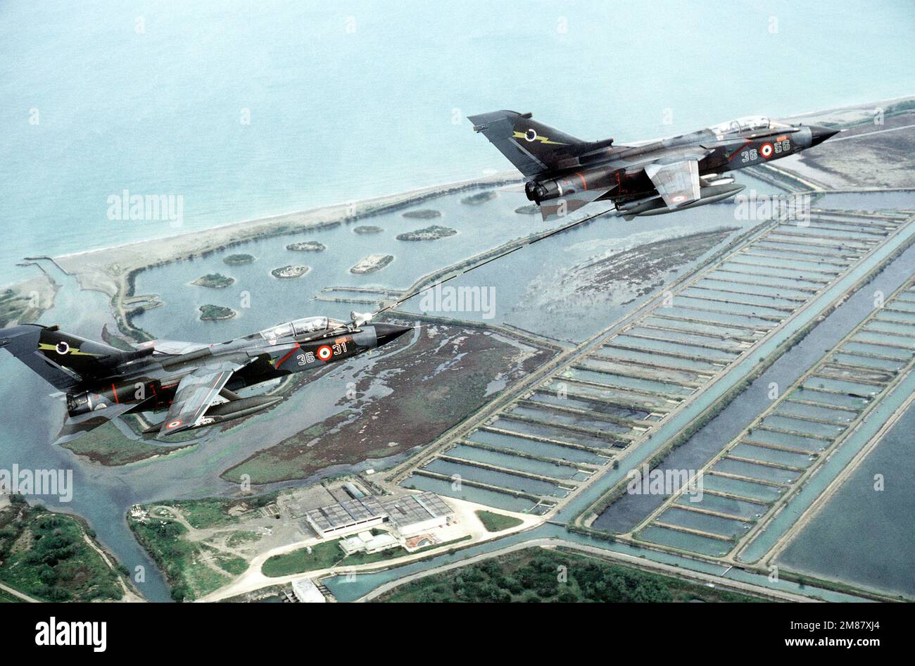 An air-to-air right side view of two Italian Tornado aircraft ...