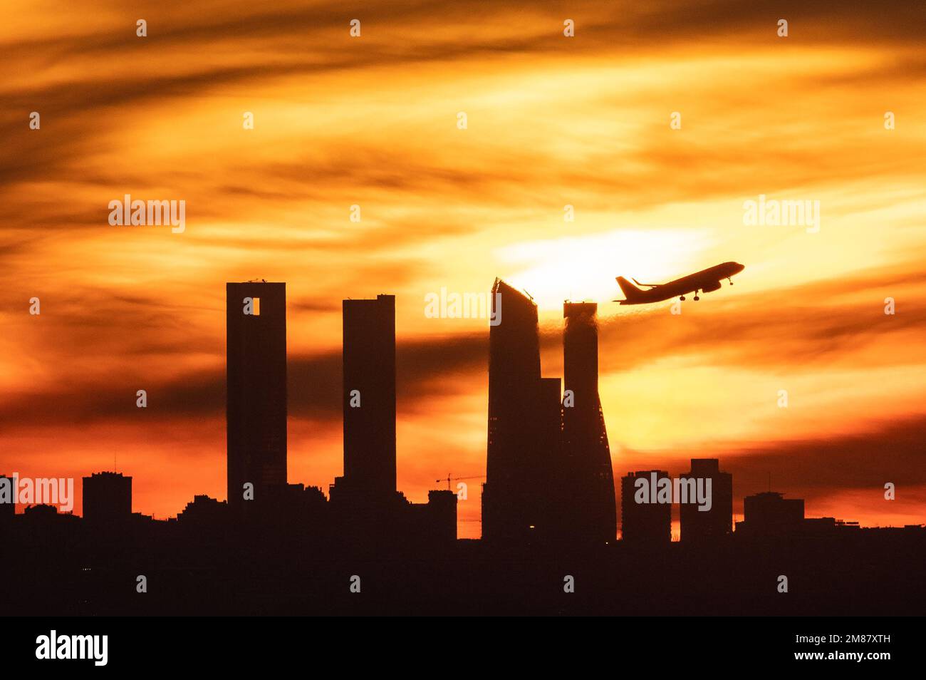 Madrid, Spain. 12th Jan, 2023. The sun silhouettes a plane as it flies ...