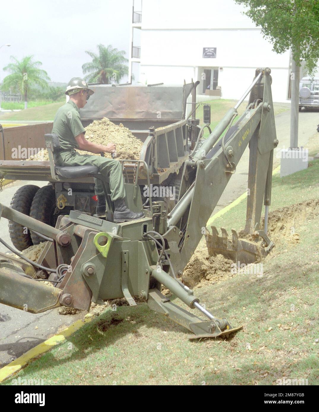 A member of Naval Mobile Construction Battalion 5 (NMCB-5) operates a ...