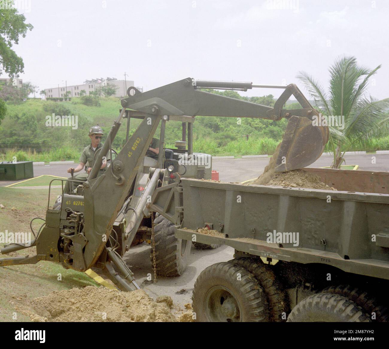 A member of Naval Mobile Construction Battalion 5 (NMCB-5) operates a ...