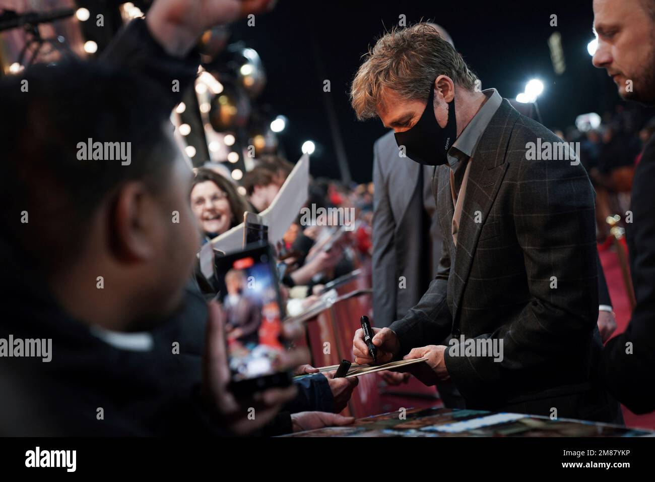 Brad Pitt signs autographs for fans upon arrival at the premiere of the ...