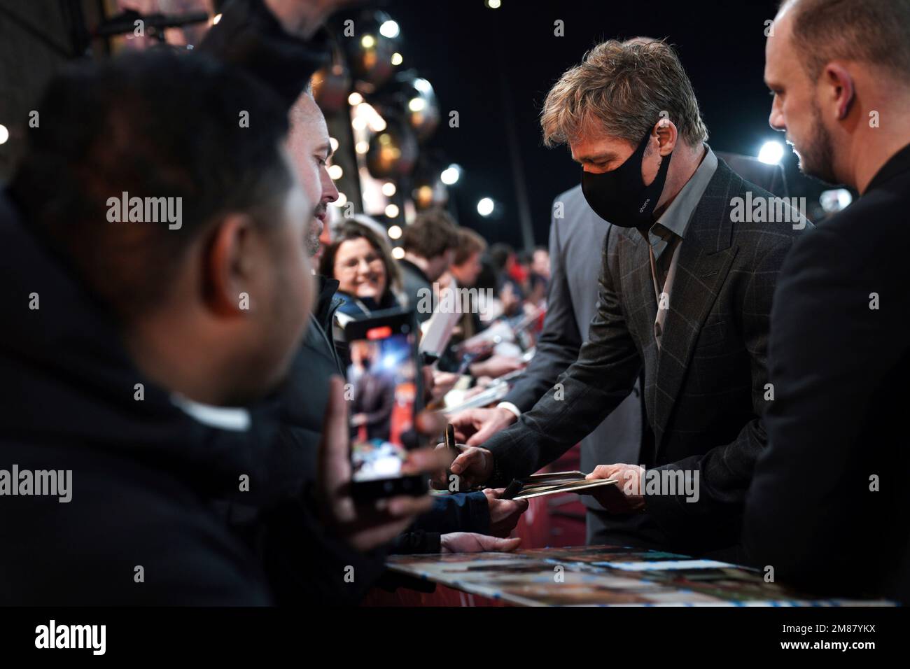 Brad Pitt signs autographs for fans upon arrival at the premiere of the ...