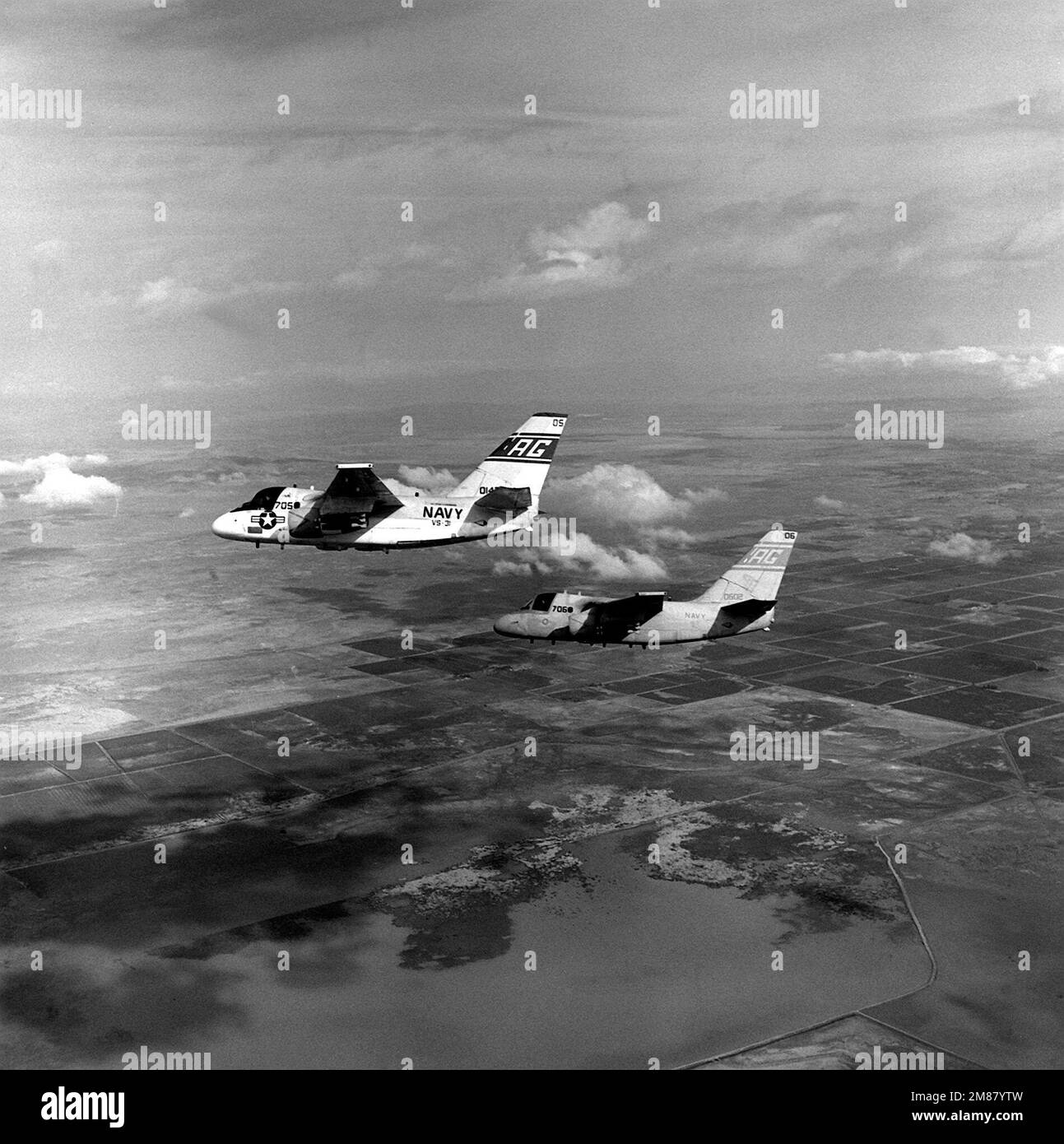 An air-to-air left side view of two Air Anti-submarine Squadron 32 (VS ...