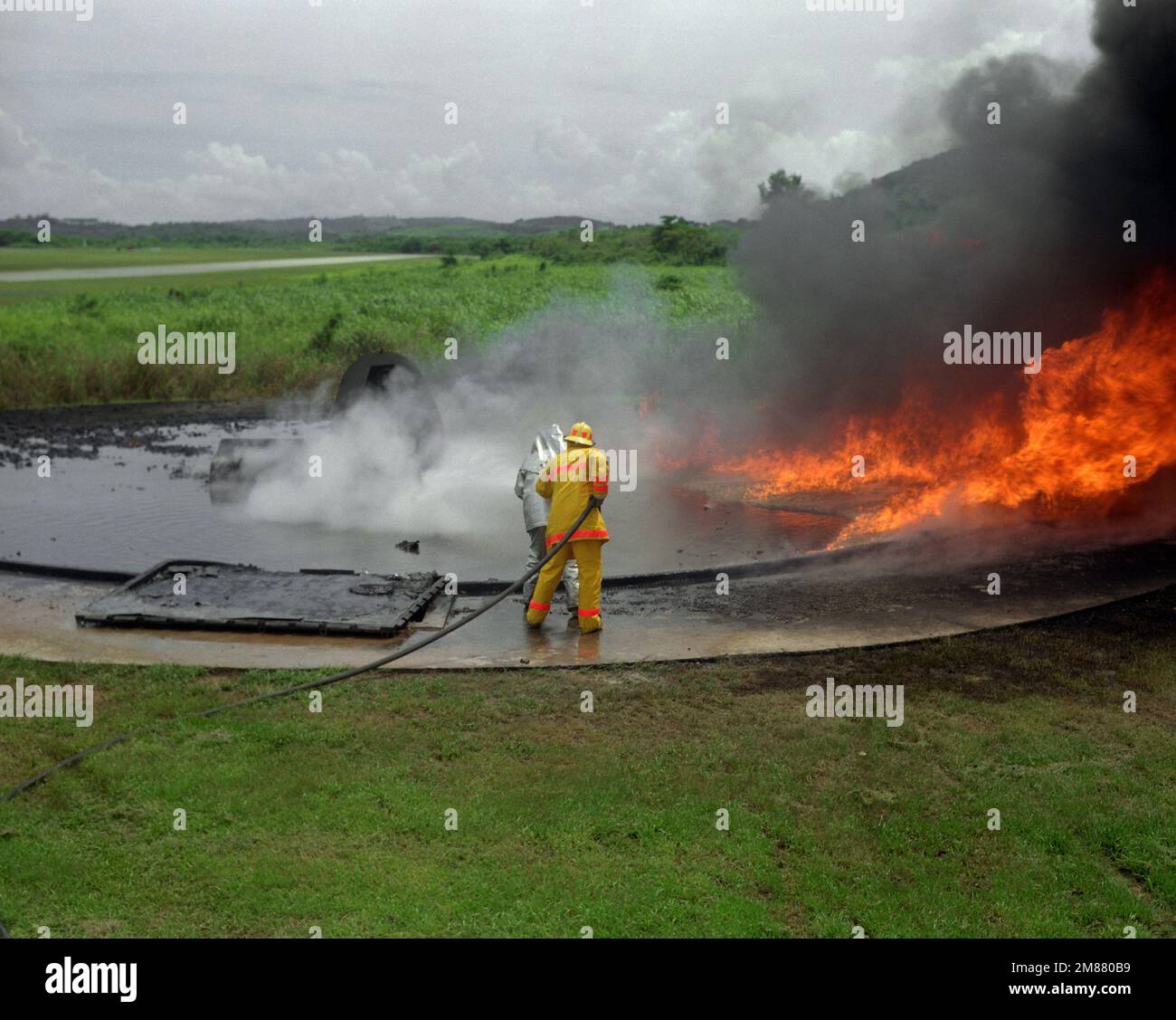 Members of a firefighting team fight a fuel fire during an aircraft ...