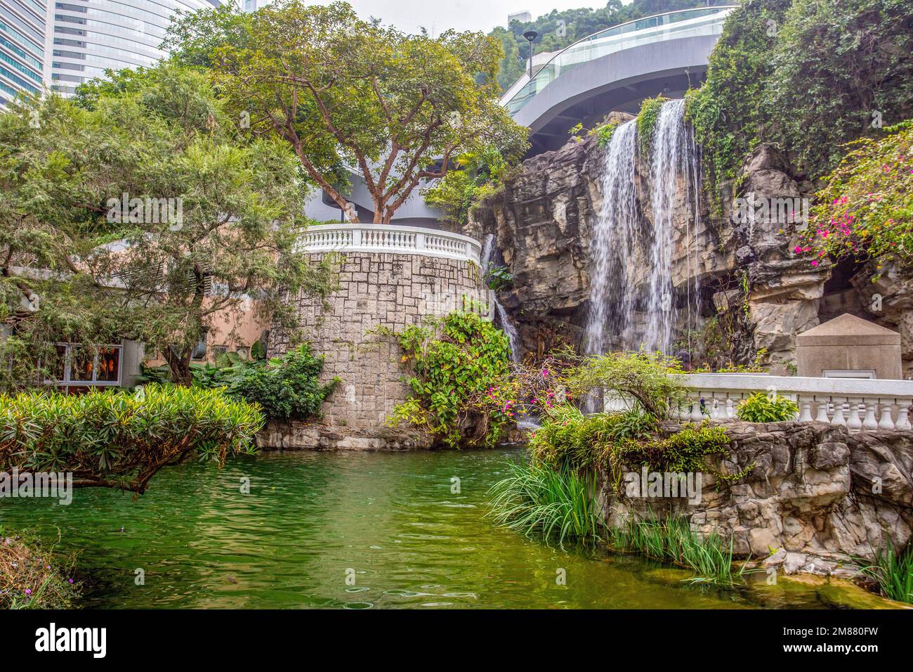 Artificial waterfall in park "Hong-Kong" and pond and nature and mount ...
