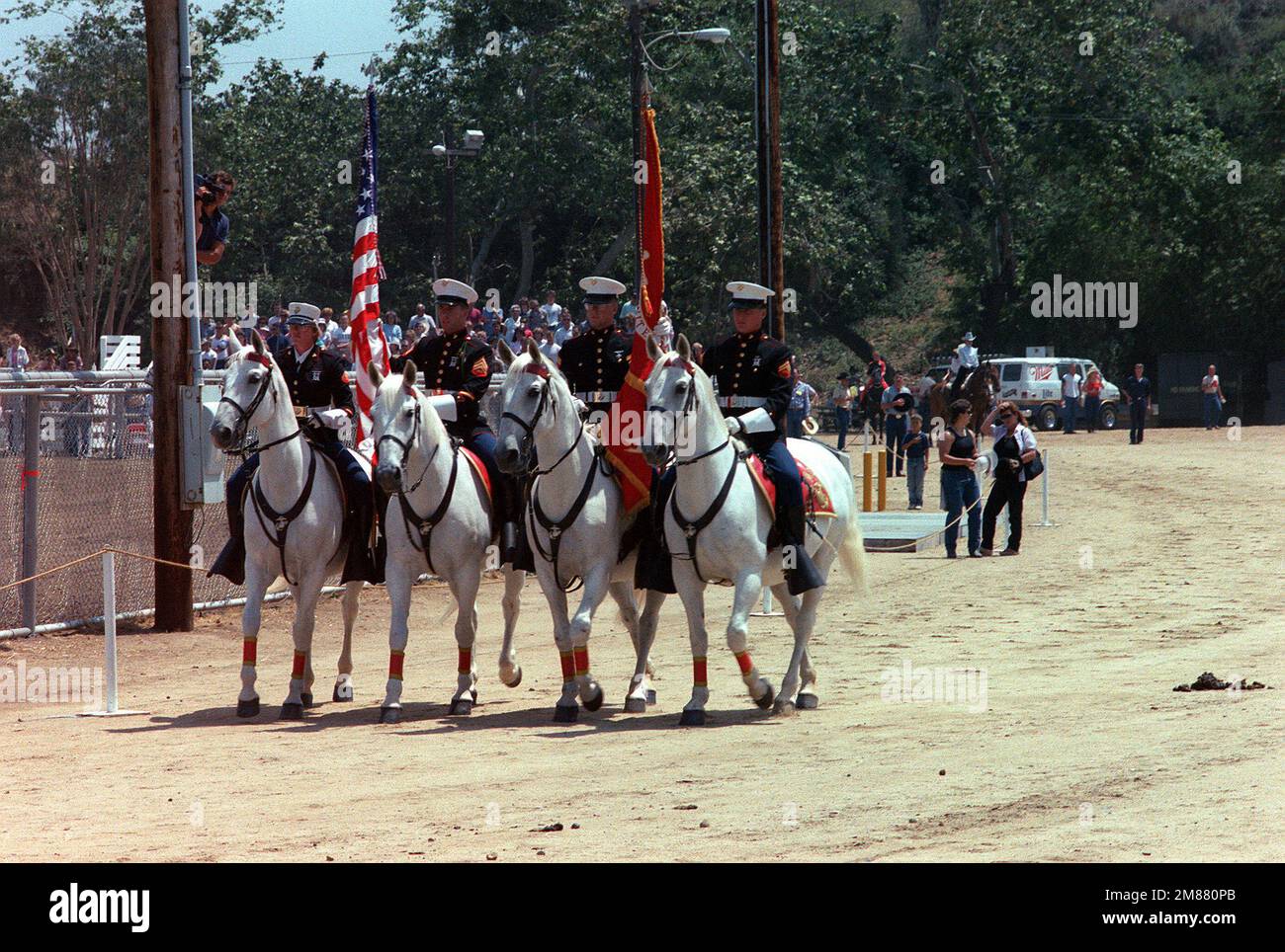 A horse-mounted color guard carries the colors into the rodeo at the ...