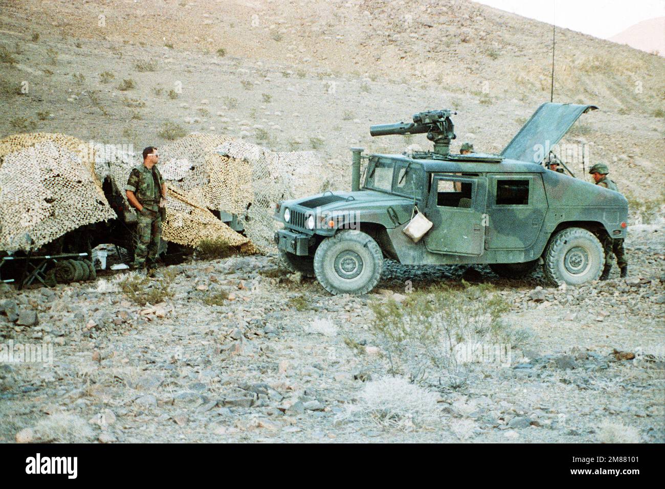 A battalion chaplain faces an M-998 multipurpose vehicle equipped with ...