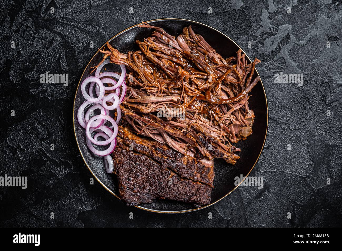 BBQ pulled pork meat on plate. Black background. Top view Stock Photo ...