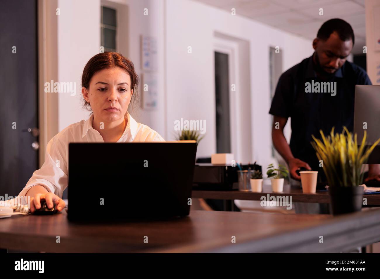Tired corporate employee working on laptop in office late, project ...